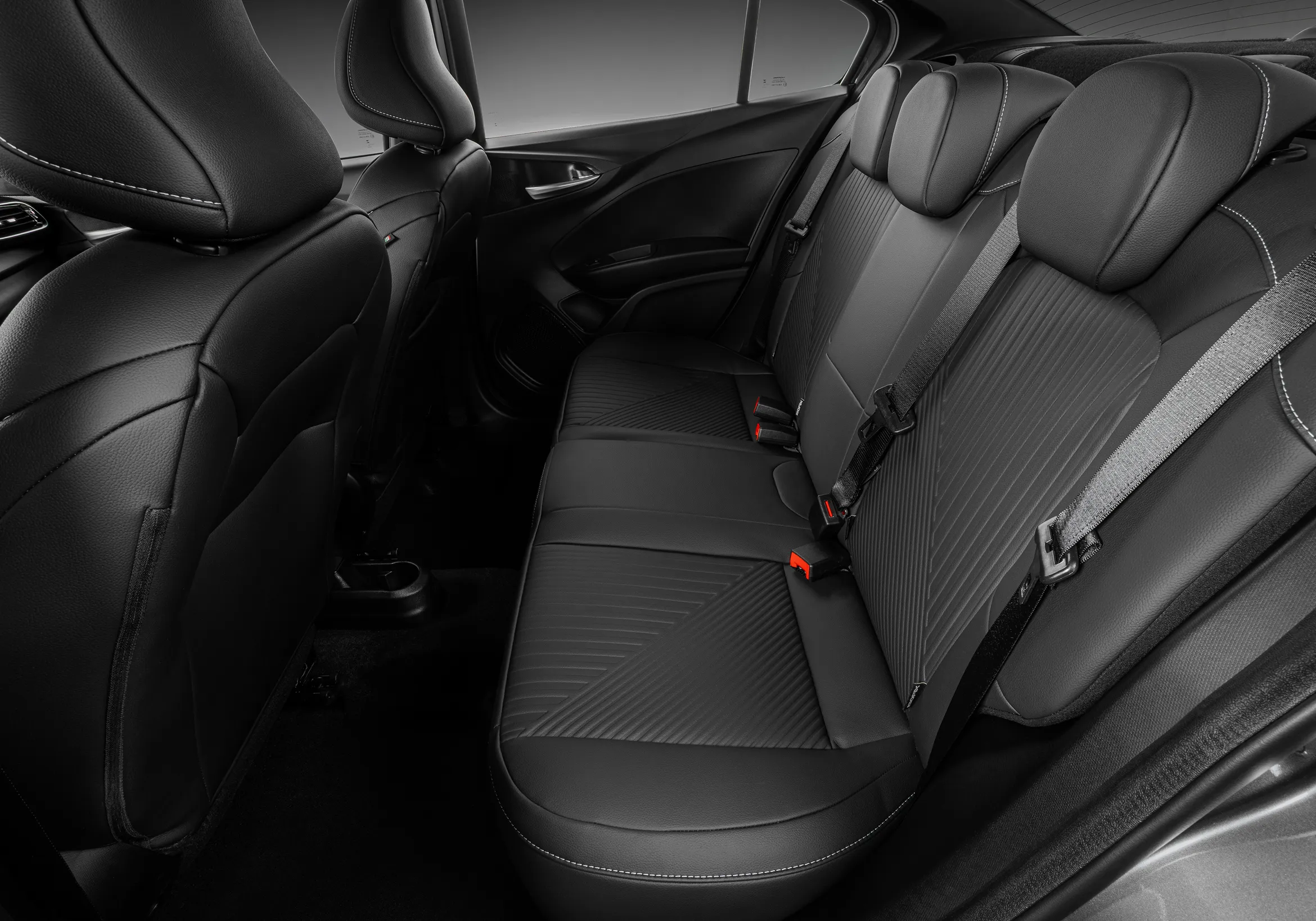 Parte traseira do interior do Fiat Cronos, com destaque para bancos com ...